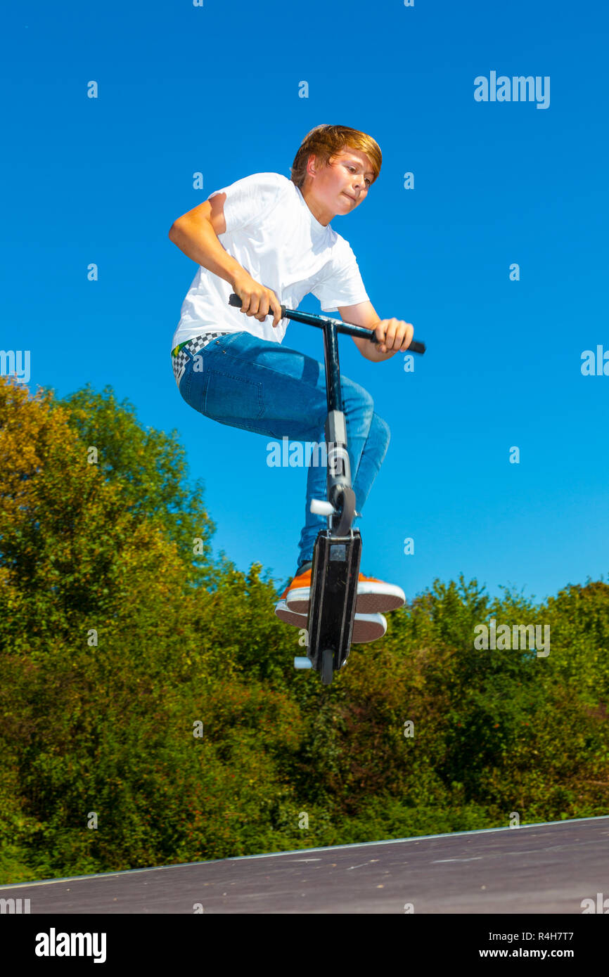 boy jumping with his scooter Stock Photo - Alamy