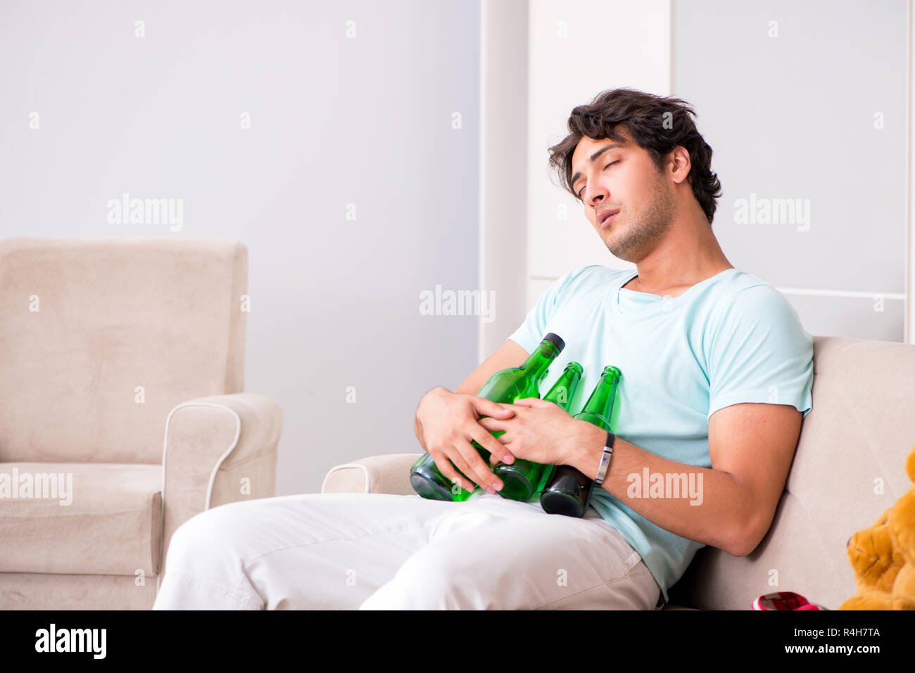 Young drunk handsome man after party at home Stock Photo - Alamy