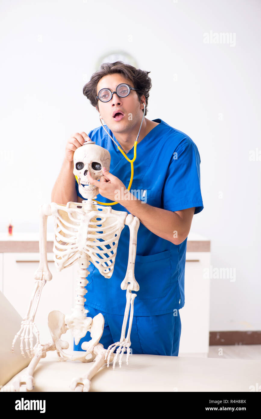 Funny doctor with skeleton in hospital Stock Photo - Alamy