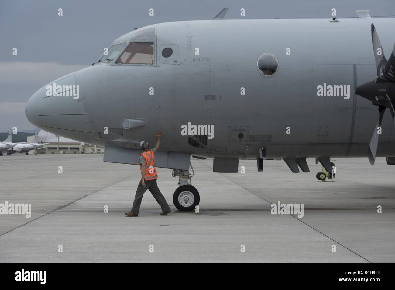 A Royal Australian Air Force member performs pre-flight activities for ...