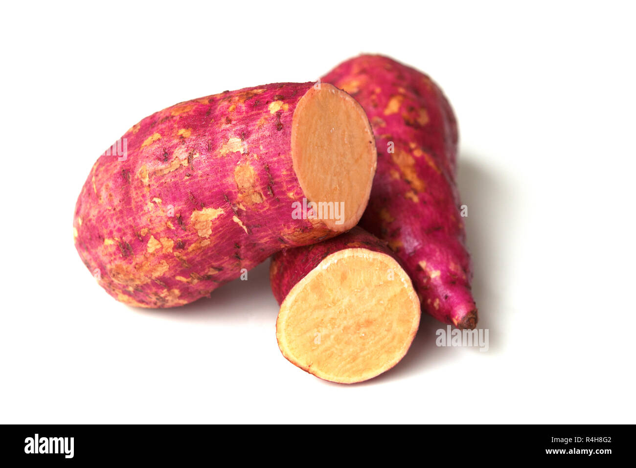 Raw sweet potato close up isolated on white background Stock Photo - Alamy