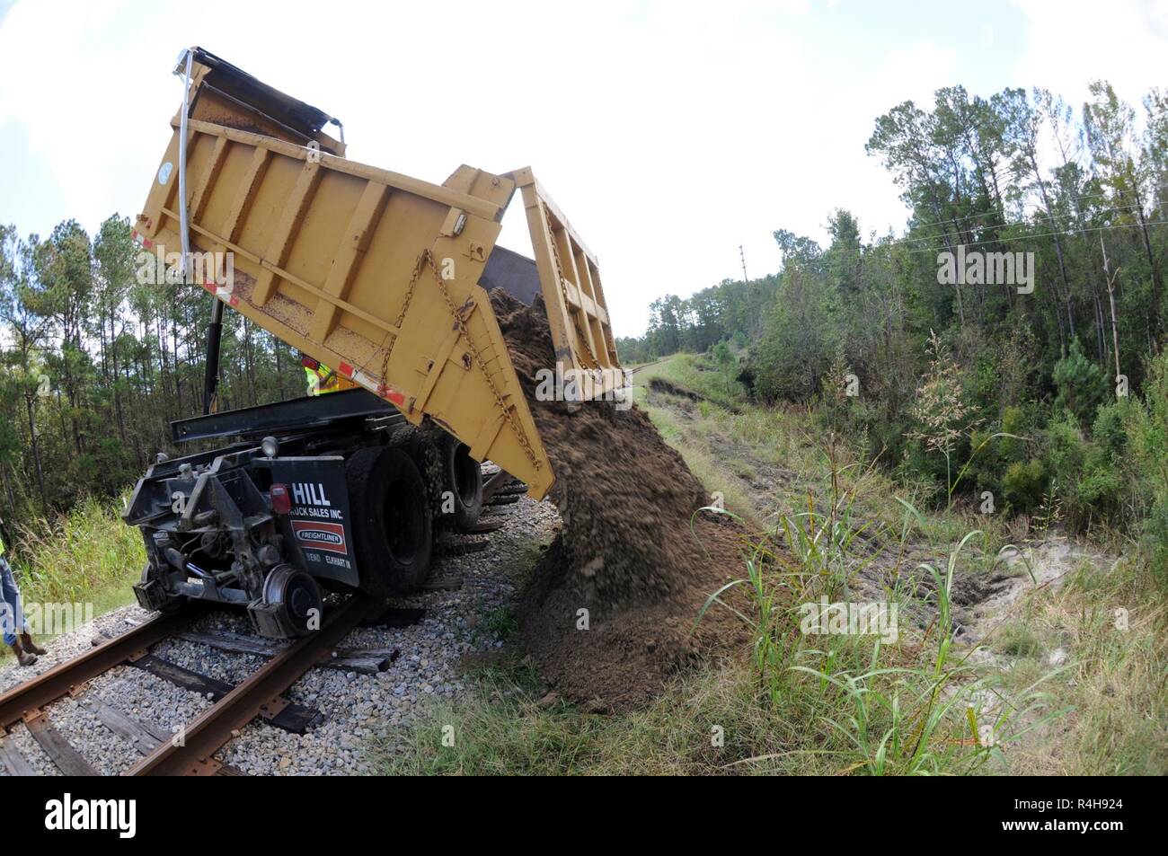 A high rail rotary dump truck from Civil Works Contracting, (CWC) dumps ...