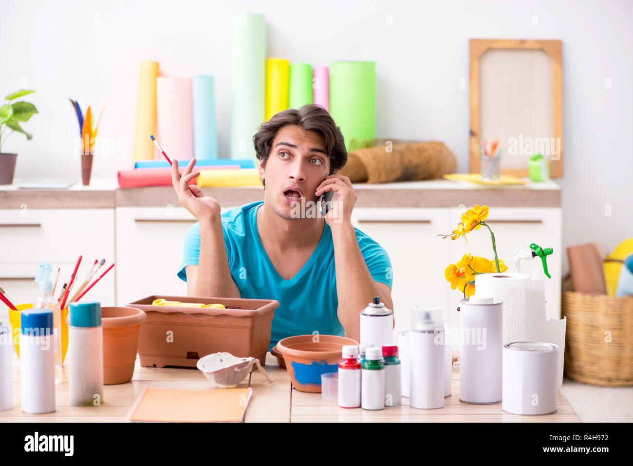 Young man decorating pottery in class Stock Photo - Alamy