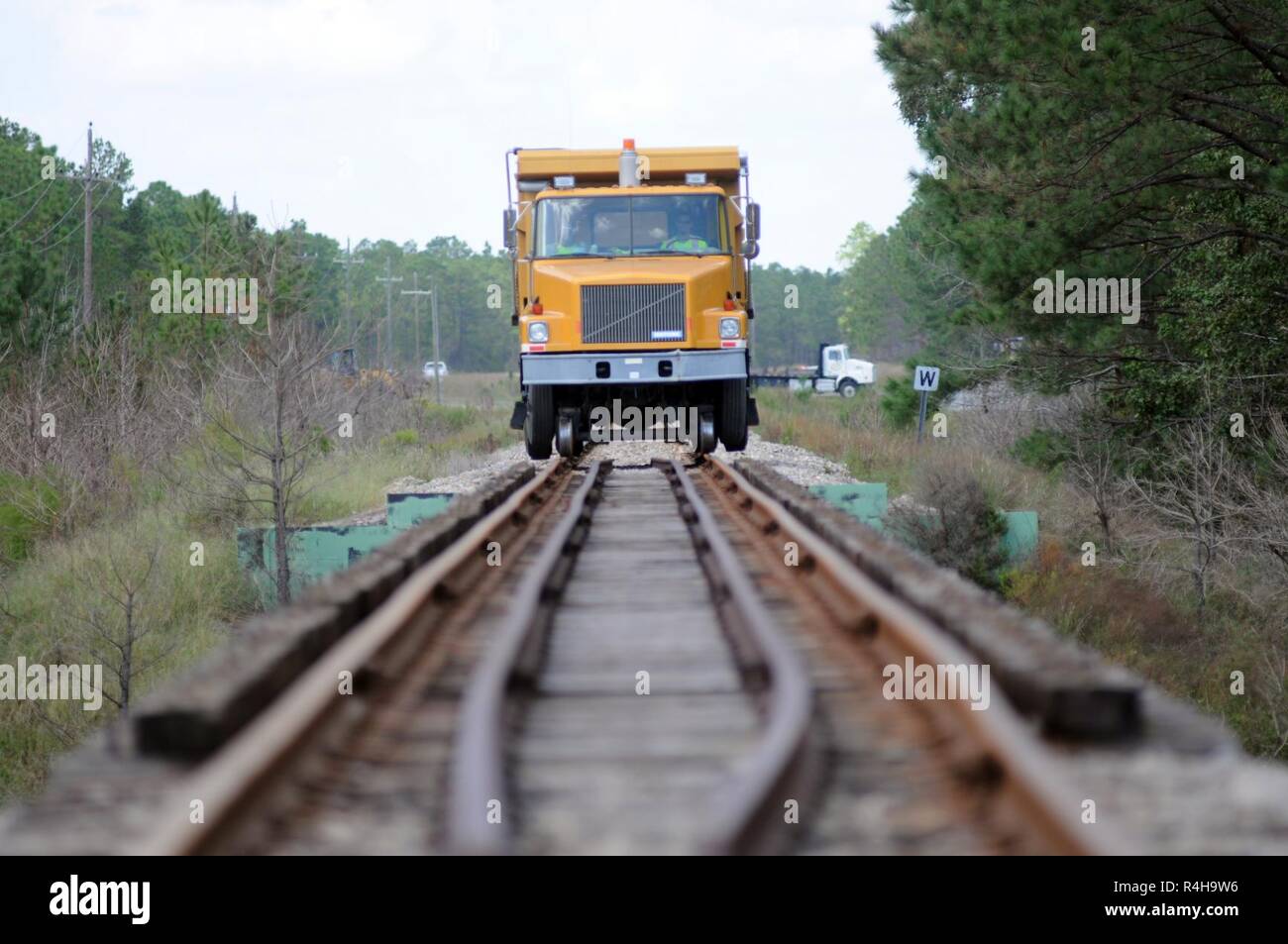 A high rail rotary dump truck from Civil Works Contracting, (CWC) rides ...