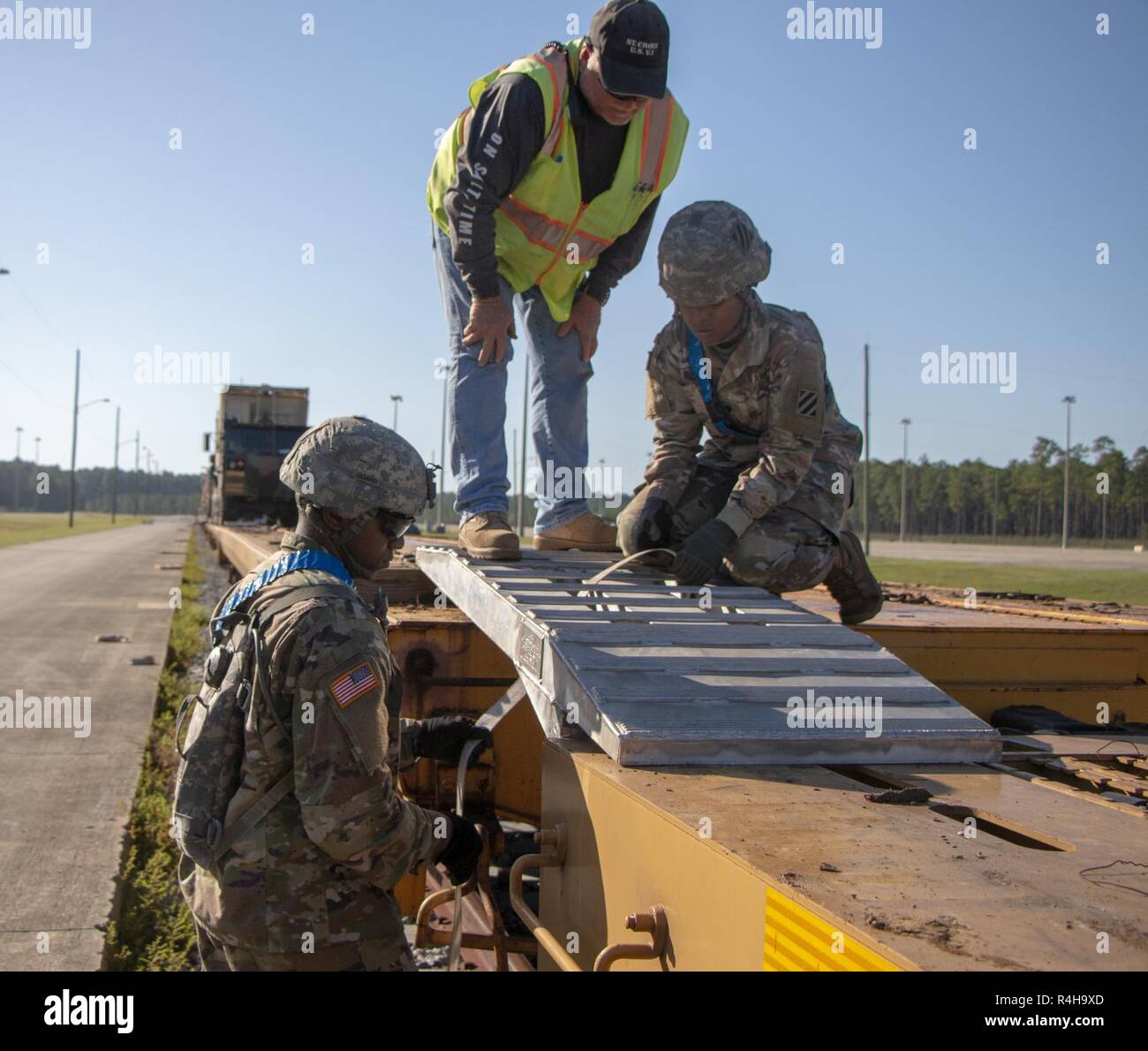 A rail marshalling area employee observes Soldiers assigned to 2nd ...
