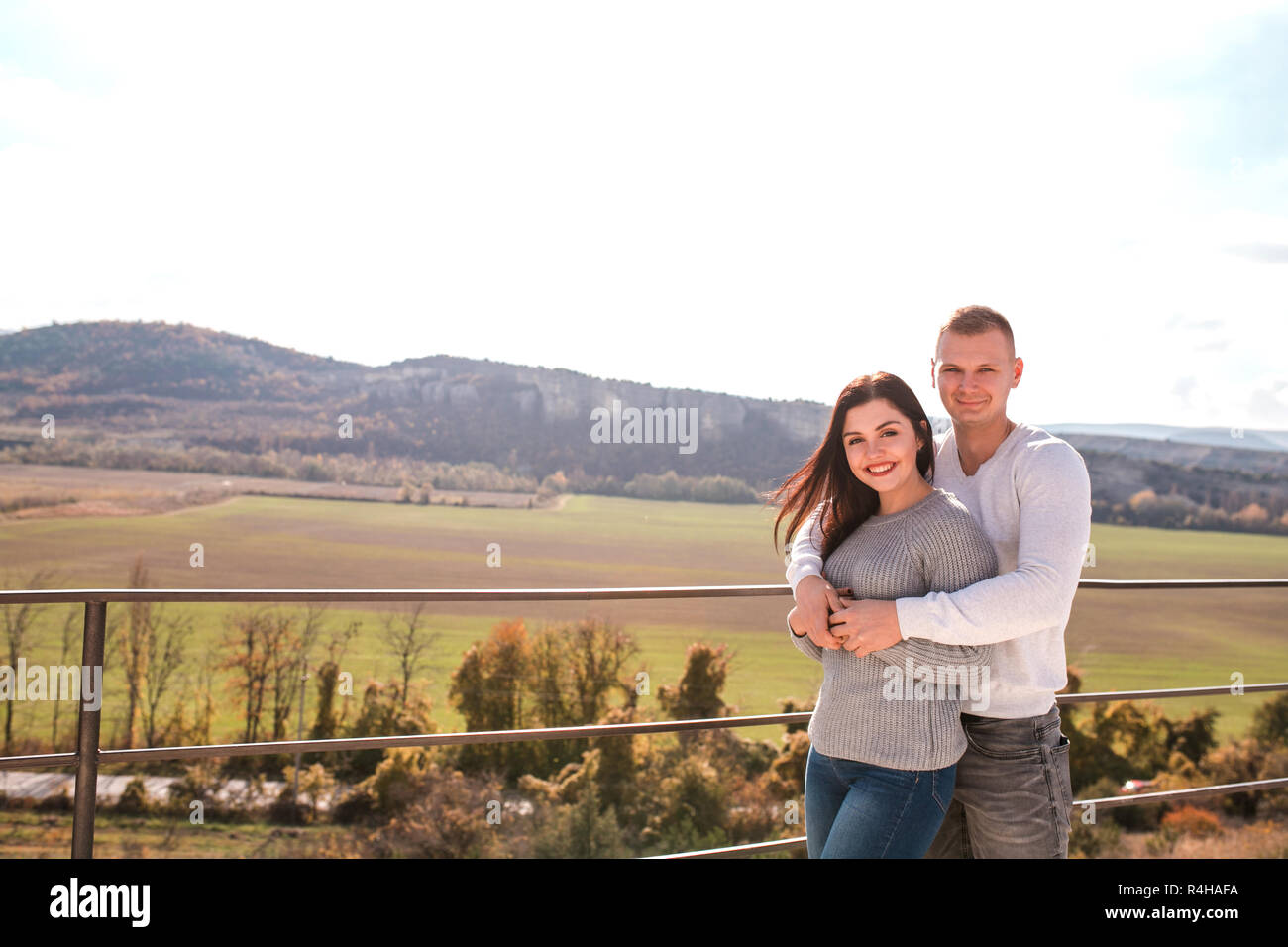 Romantic young couple hugging and smiling outdoors Stock Photo - Alamy