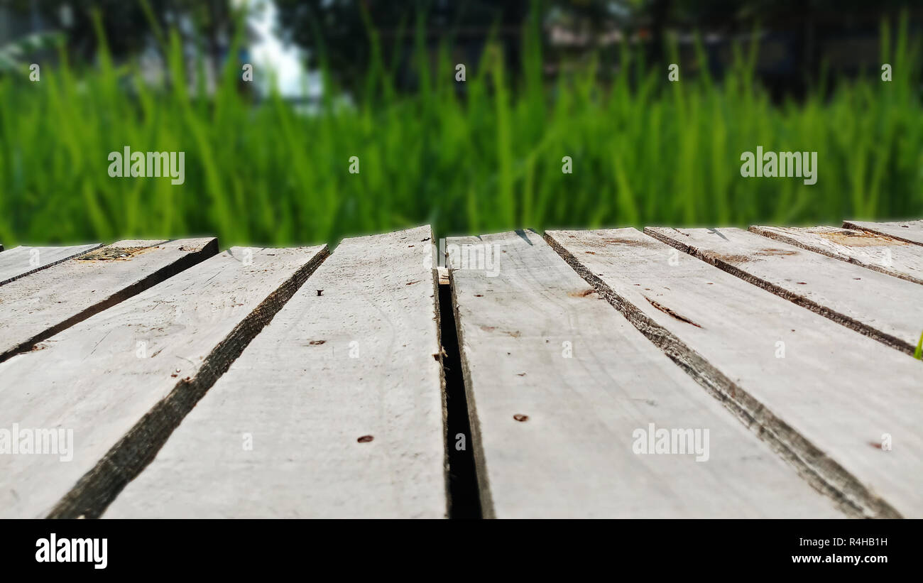 Natural wooden bridge with green rice field background Stock Photo - Alamy