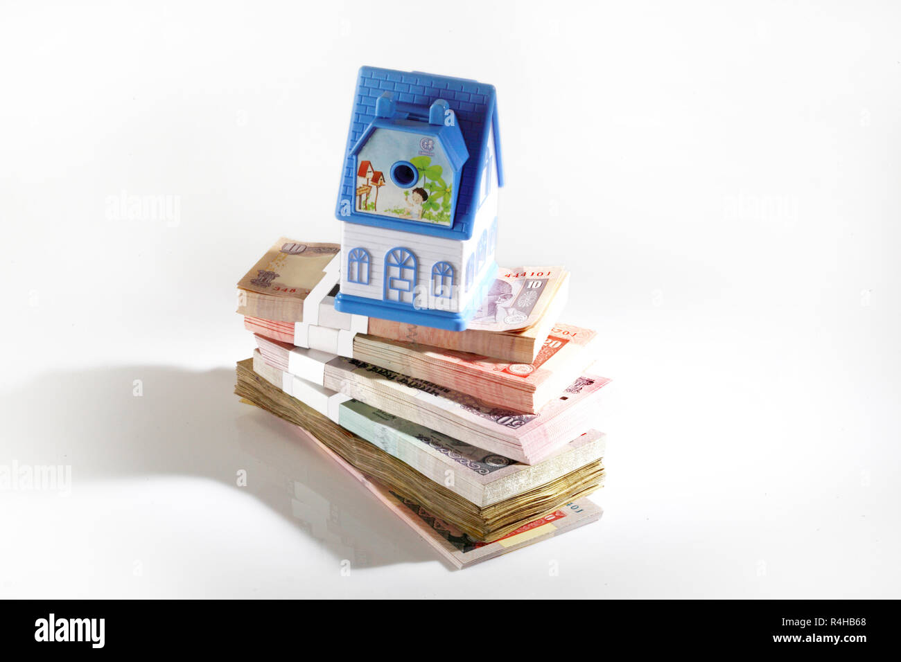 House on money stack Stock Photo - Alamy