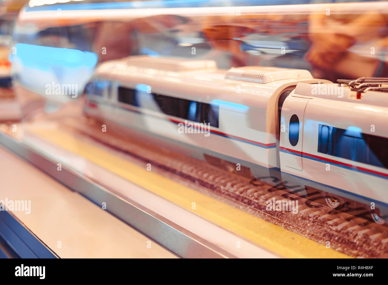 Miniature toy model of modern train crossing bridge Stock Photo - Alamy