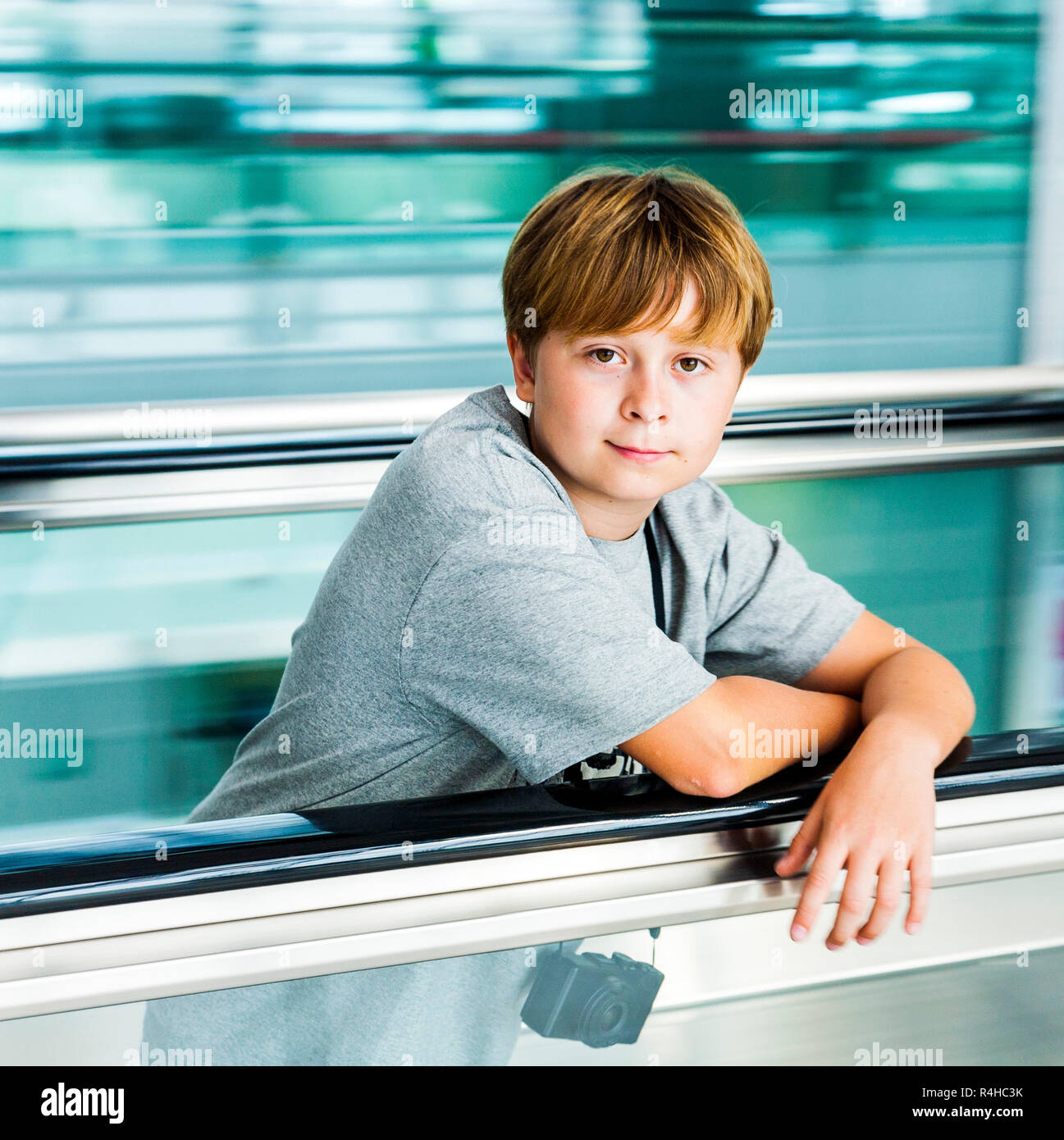 boy on moving staircase Stock Photo - Alamy