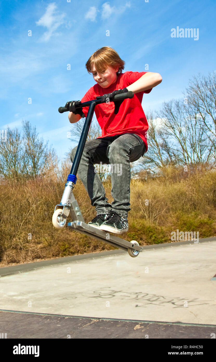 Boy going airborne with a scooter Stock Photo - Alamy