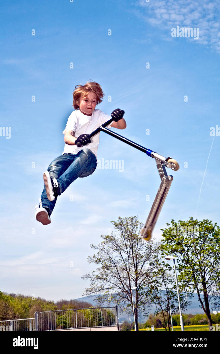Boy going airborne with a scooter Stock Photo - Alamy