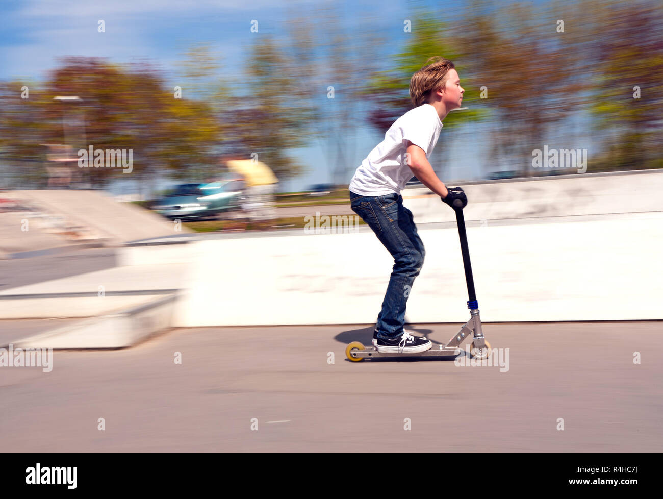 boy riding with speed on his scooter Stock Photo - Alamy