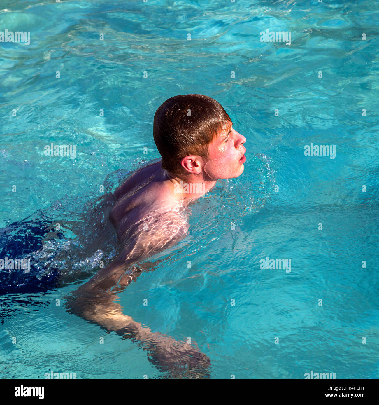 boy enjoys swimming in the pool Stock Photo - Alamy
