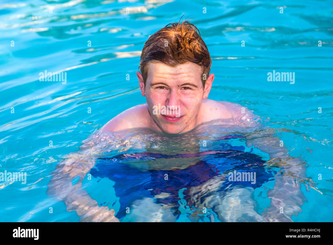 boy enjoys swimming in the pool Stock Photo - Alamy