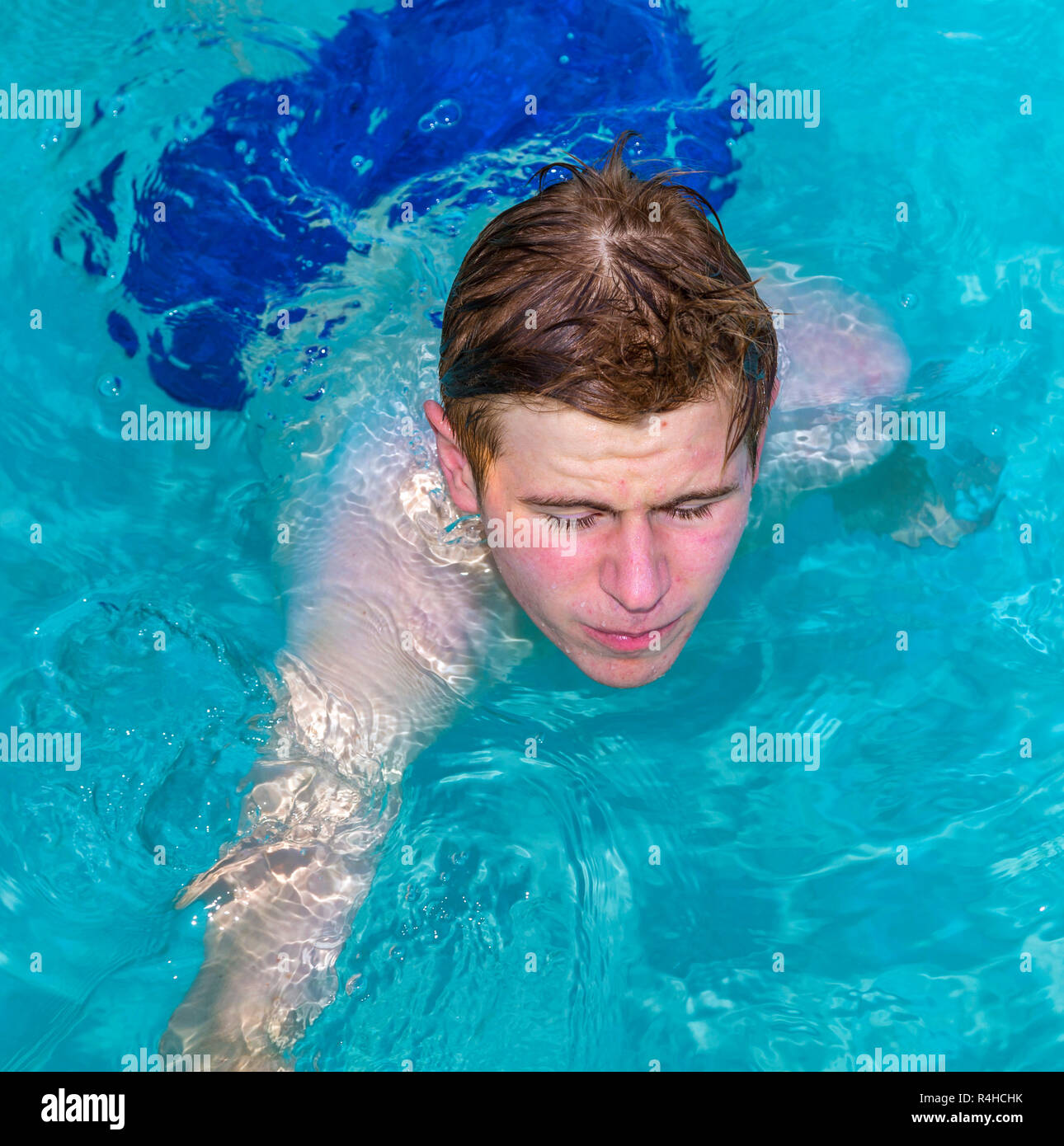 boy enjoys swimming in the pool Stock Photo - Alamy