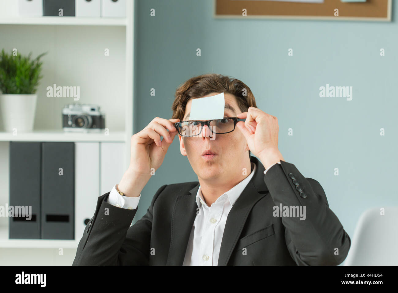 Business people, joke and fool concept - portrait of young man with ...