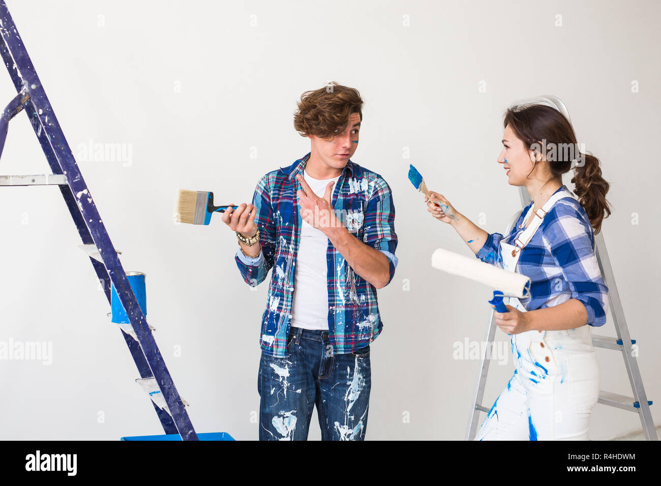 Renovation, people and emotions concept - Young woman and man with ...