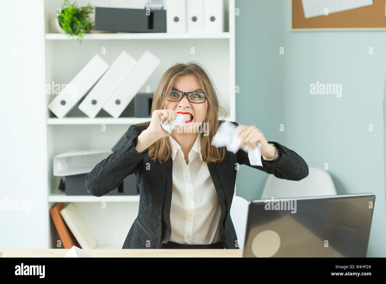 People, business and emotions concept -Young woman tearing documents ...