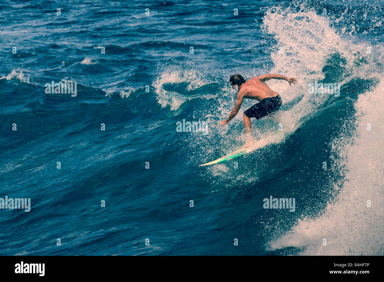 Extreme surfer riding giant ocean wave in Hawaii Stock Photo - Alamy