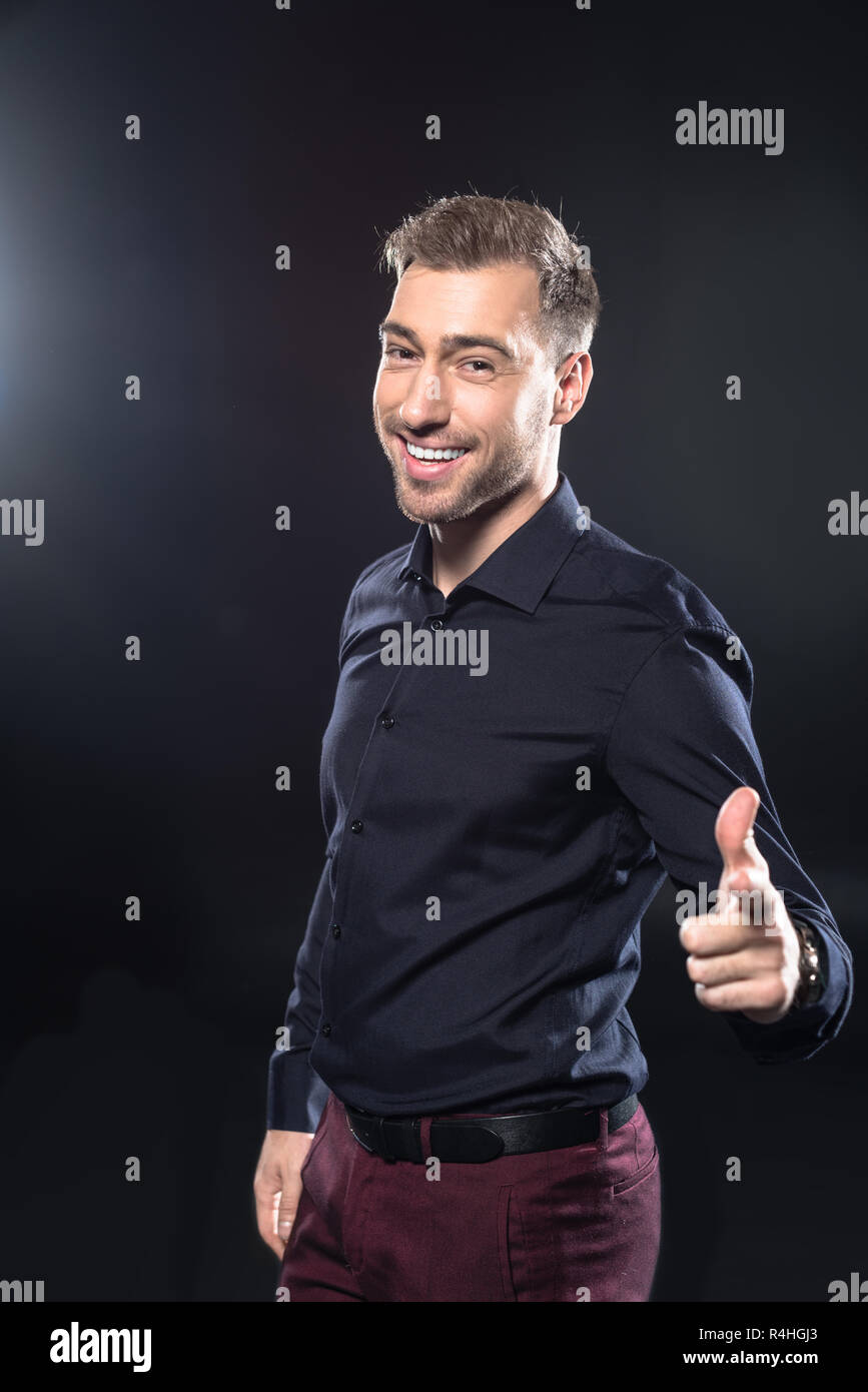 handsome happy young man pointing at camera on black Stock Photo - Alamy