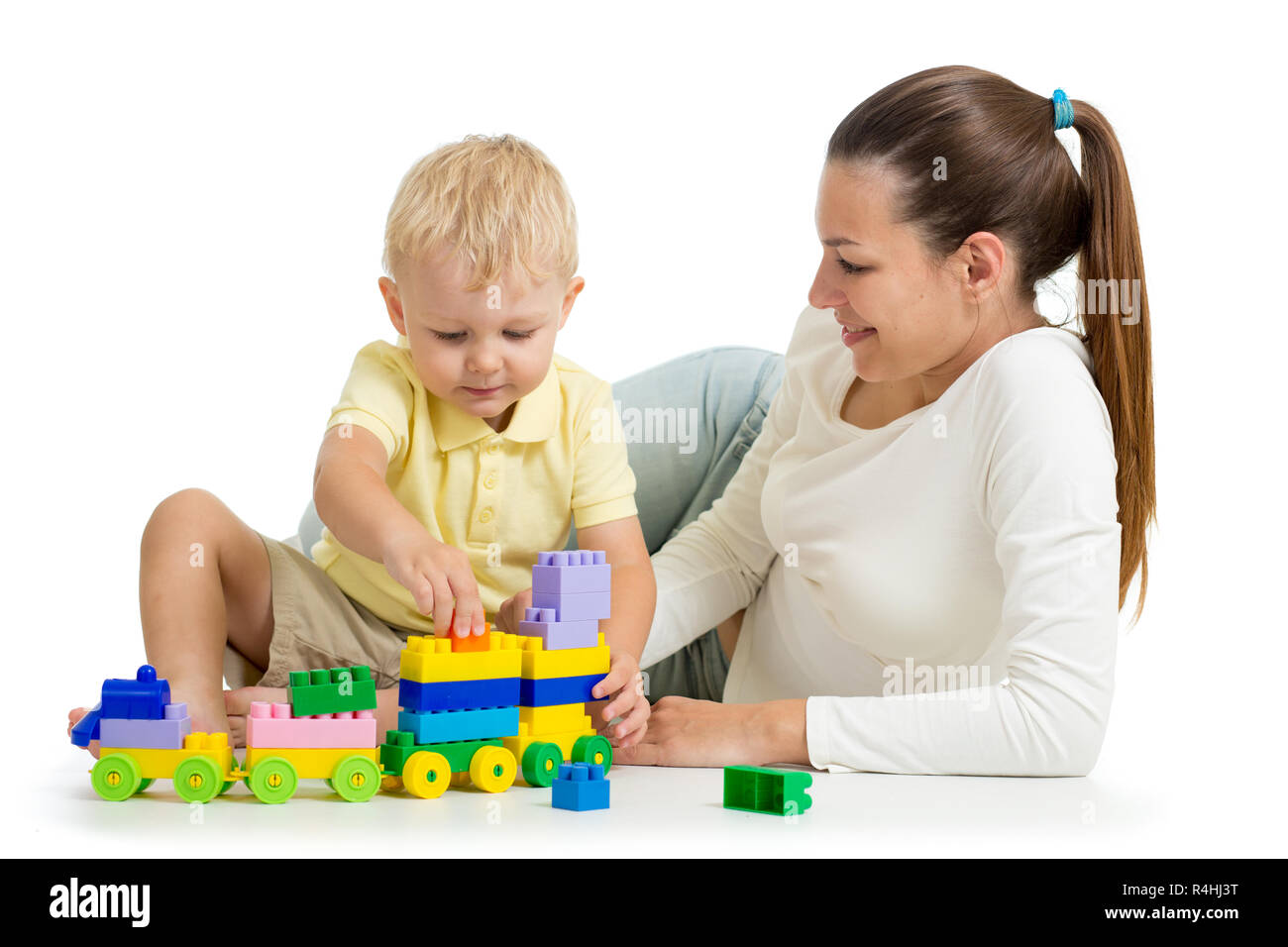 Mother and child build out of colorful plastic blocks. Family and ...