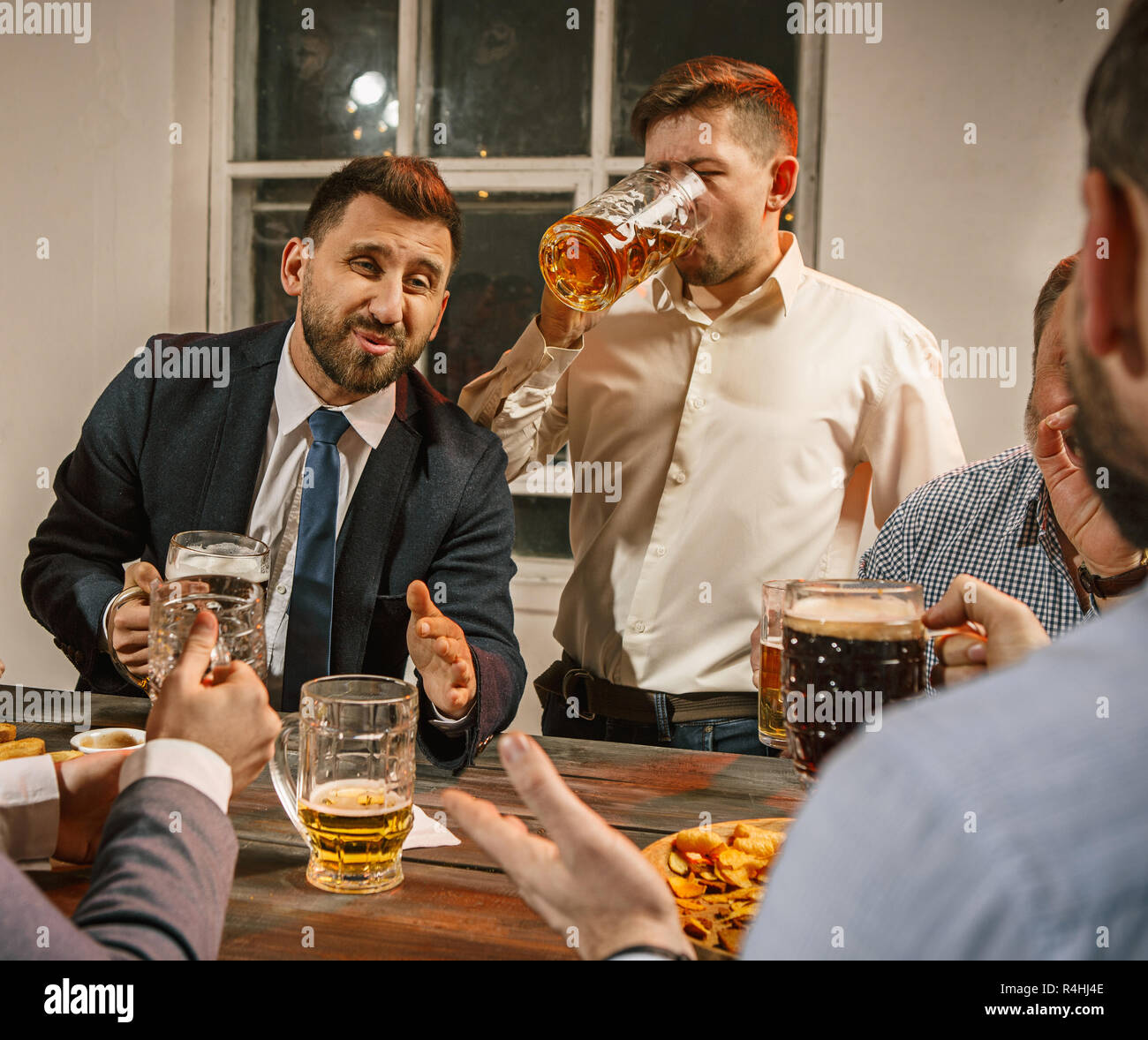 Group of friends enjoying evening drinks with beer Stock Photo - Alamy