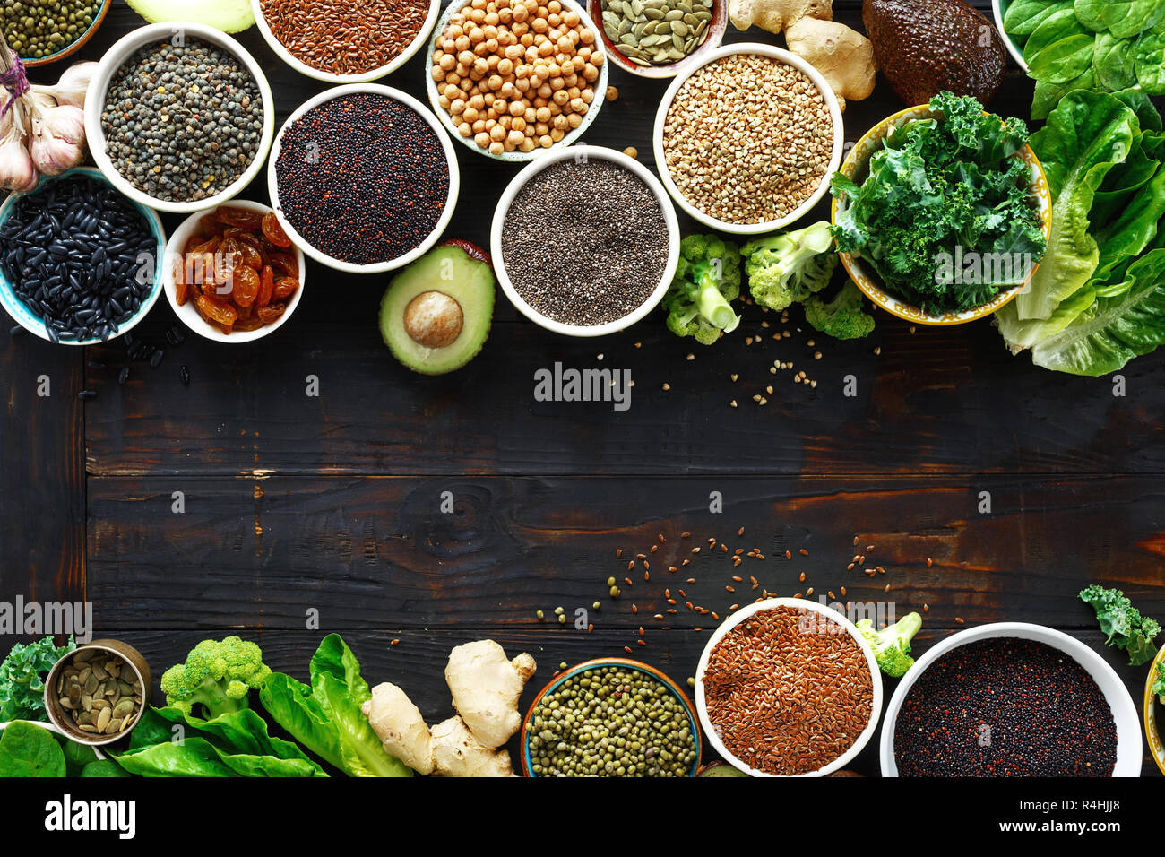 Frame of set superfoods on dark wooden table with copy space. Leaves ...