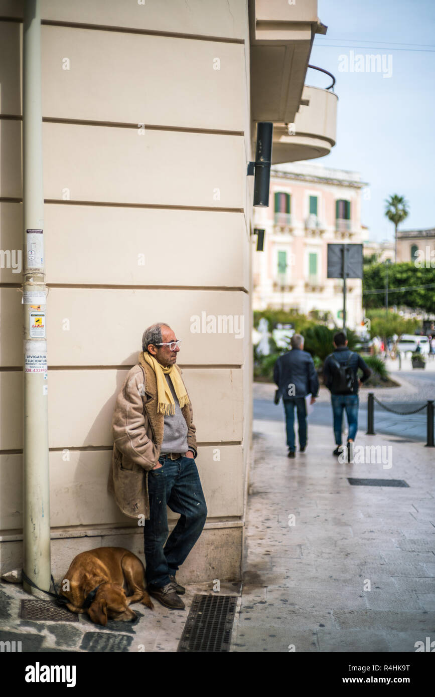 man with dog in the street of the Syracuse, Sicily, Italy, Europe Stock ...