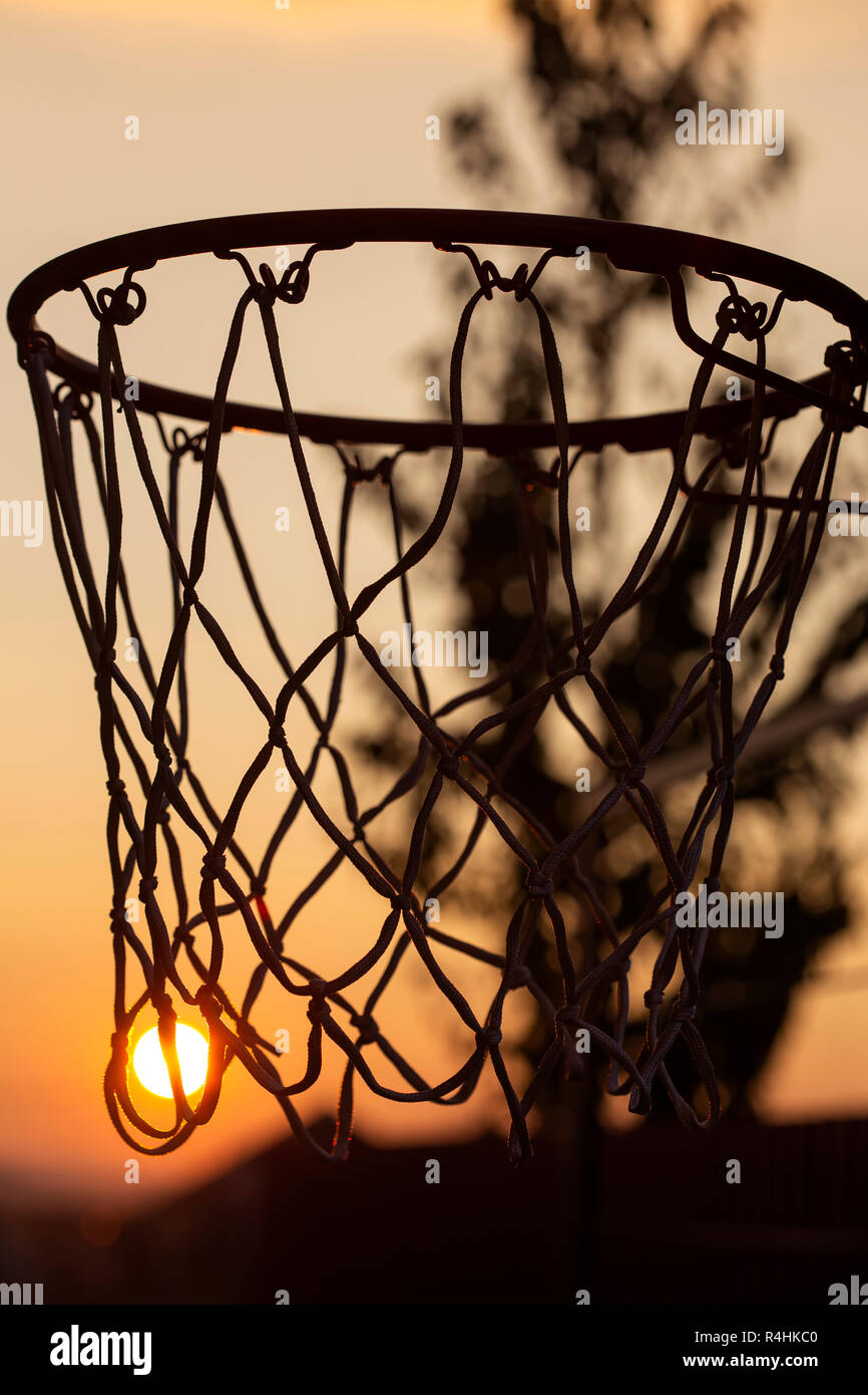 Silhouette of a basketball hoop, under the sunset - close up view Stock ...