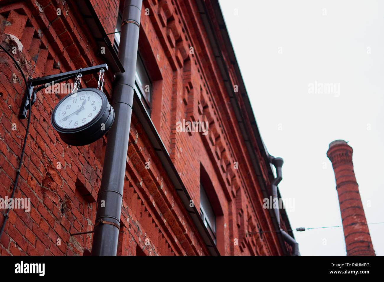 clock on a brick building on the street hanging on the corner Stock ...