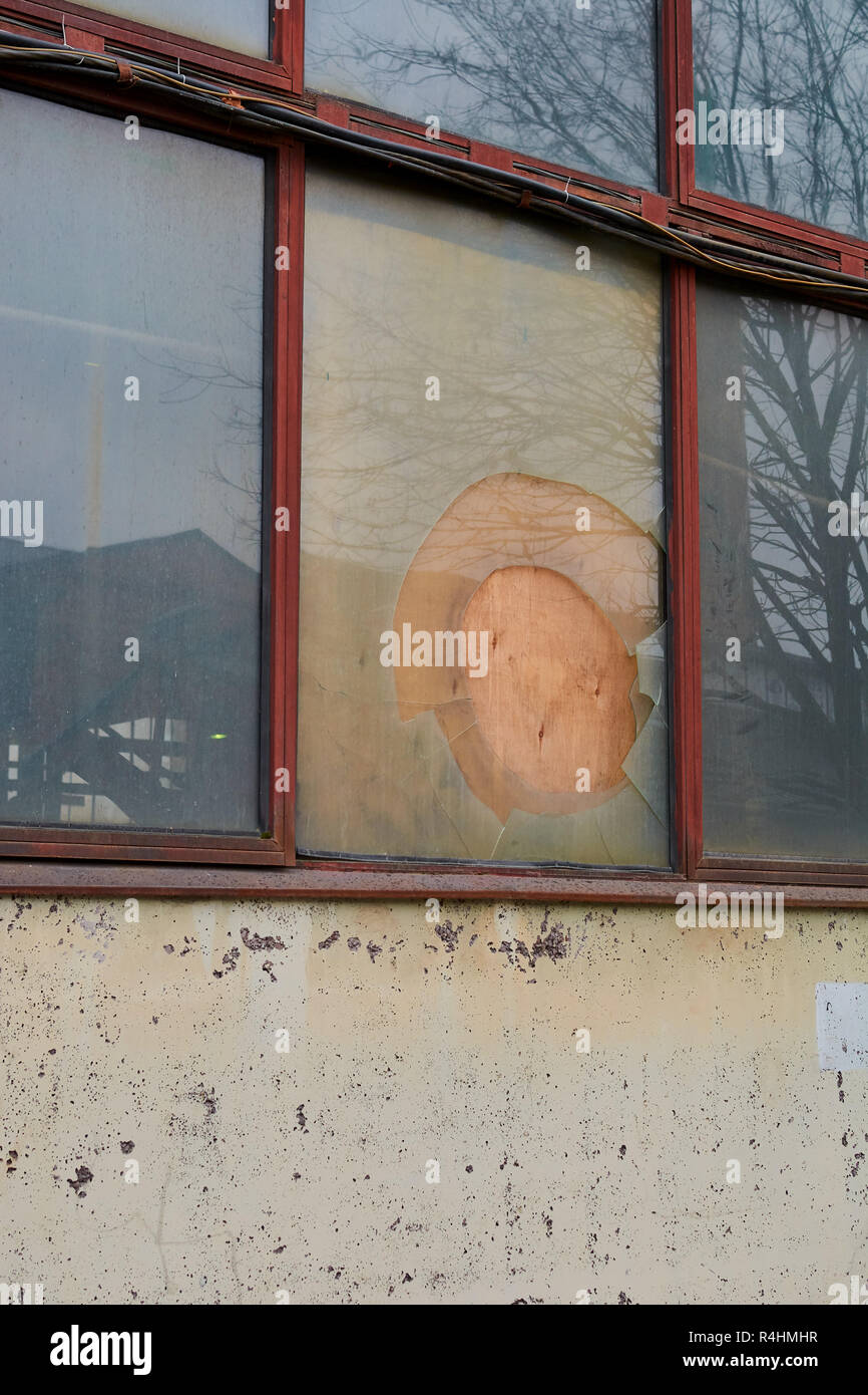 broken window in the house with a wooden insert in the window Stock ...