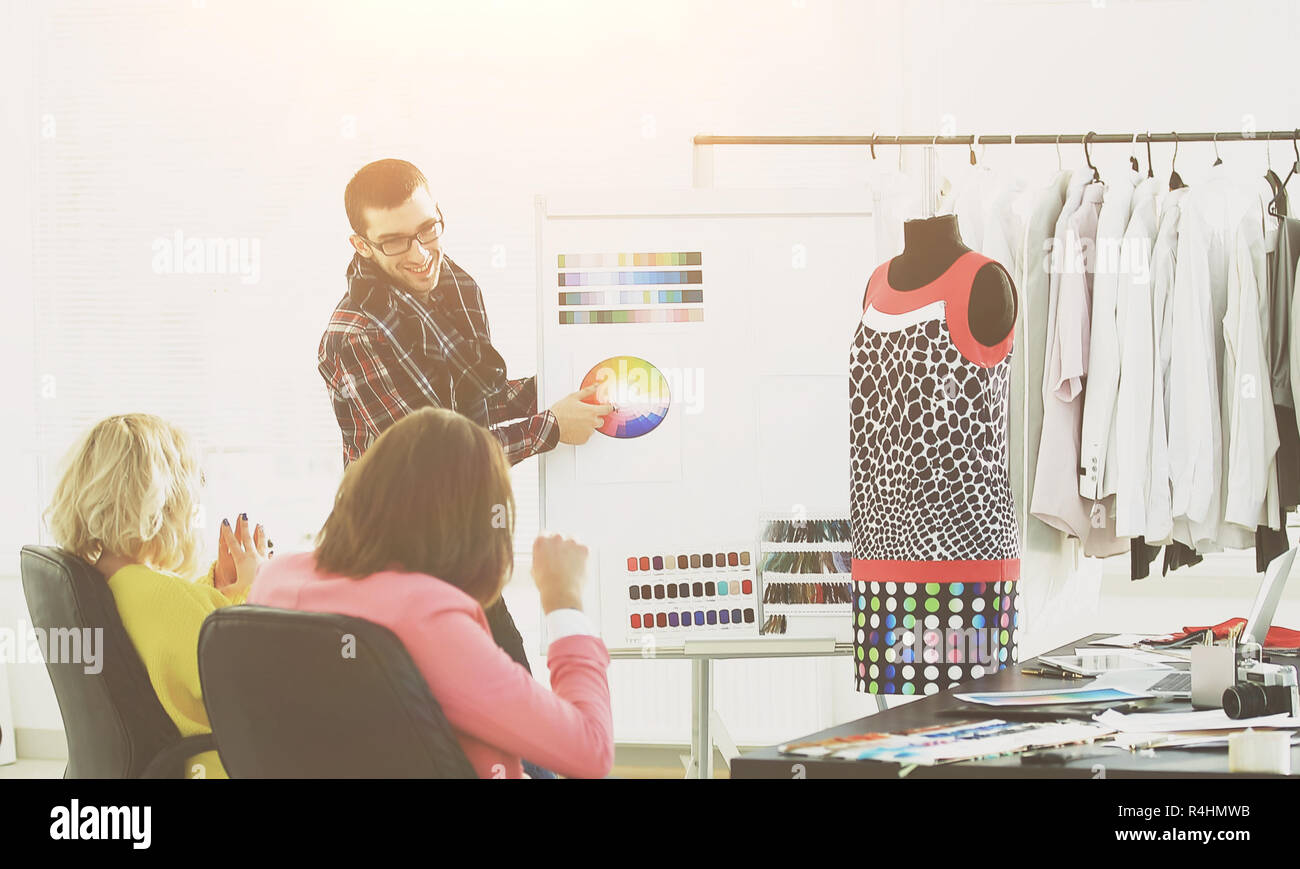 group of designers discussing a new clothing collection Stock Photo - Alamy