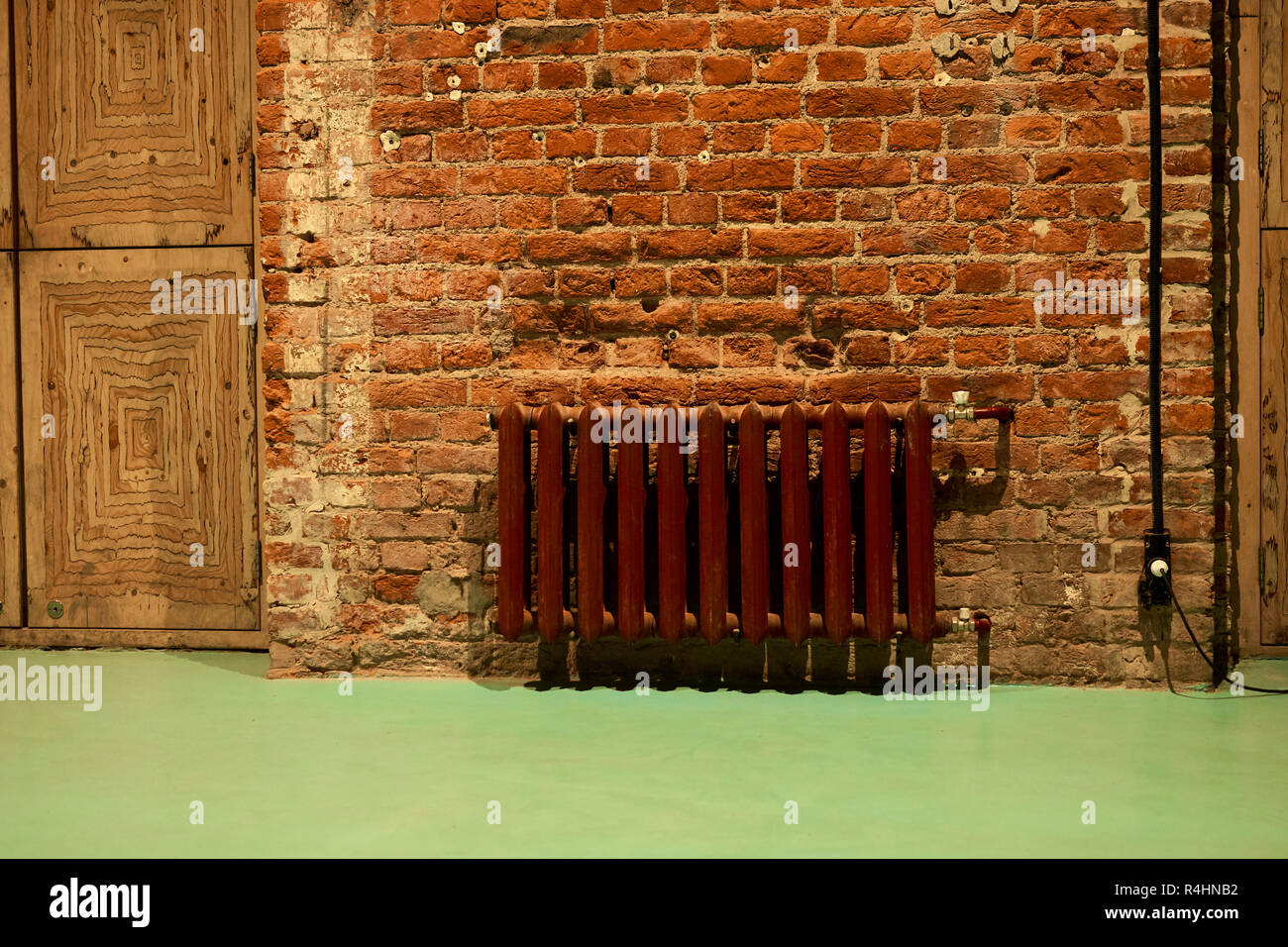 the iron battery rusty about a brick wall old and destroyed Stock Photo ...