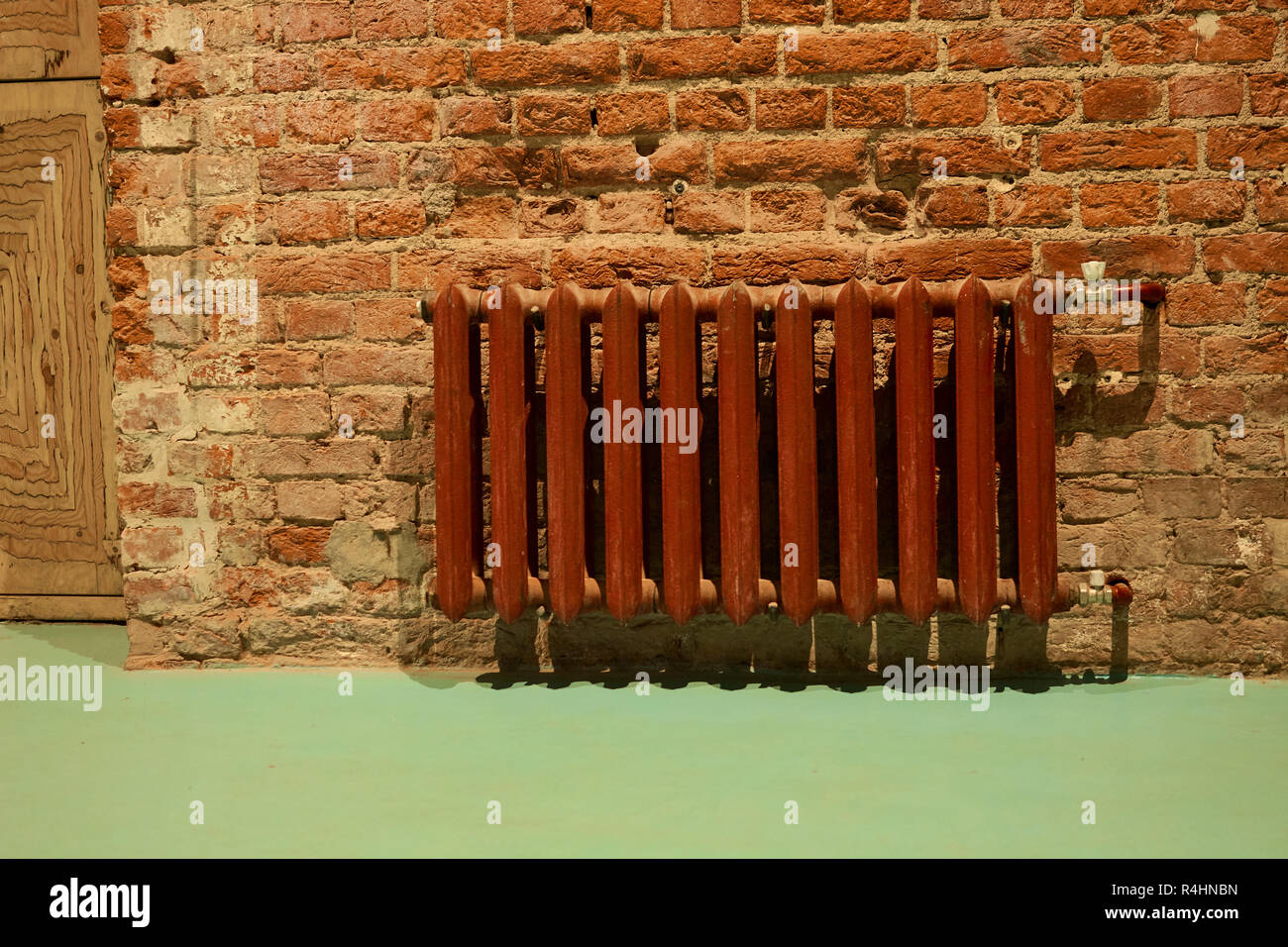 the iron battery rusty about a brick wall old and destroyed Stock Photo ...