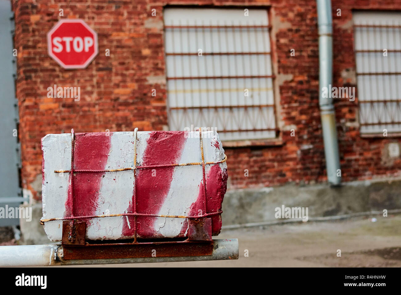 stop sign on iron background and near brick wall Stock Photo - Alamy