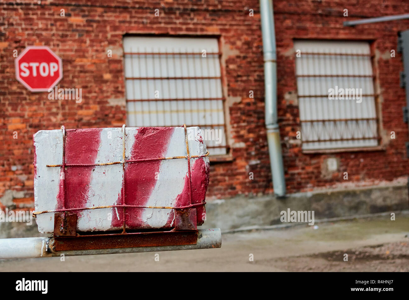 stop sign on iron background and near brick wall Stock Photo - Alamy