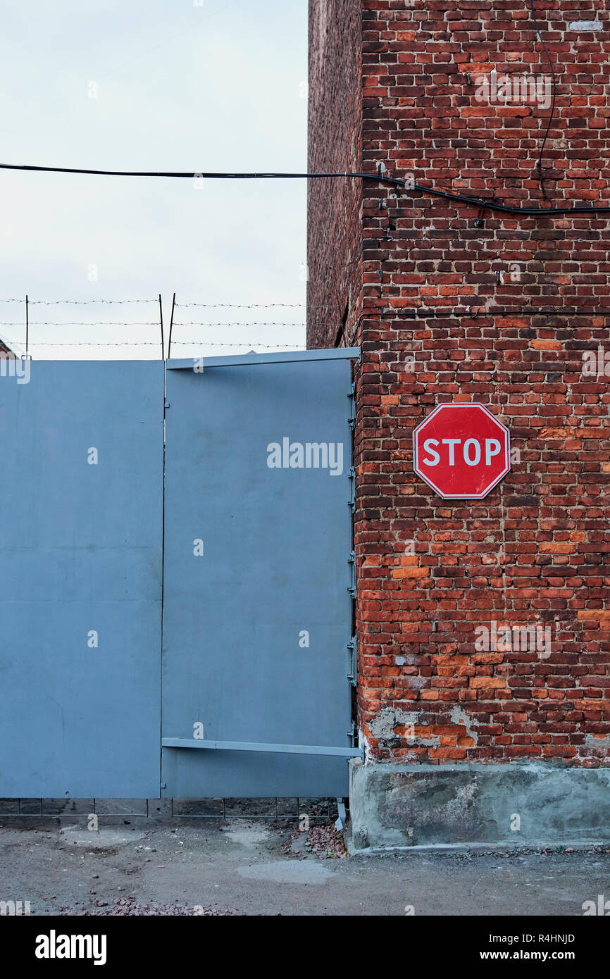stop sign on iron background and near brick wall Stock Photo - Alamy