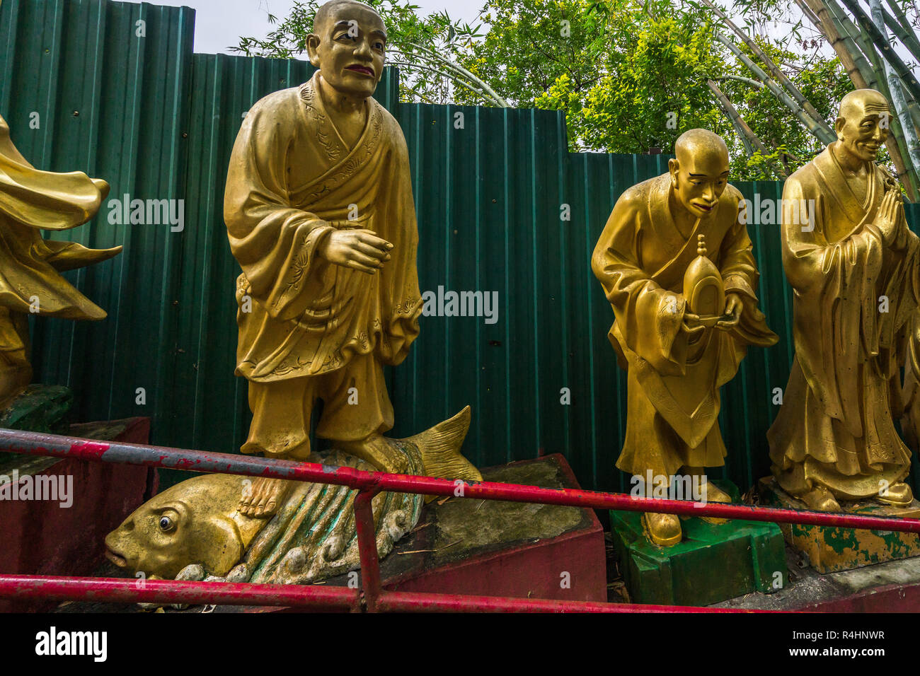 Three golden Buddha statues along the path to Ten Thousand Buddhas ...