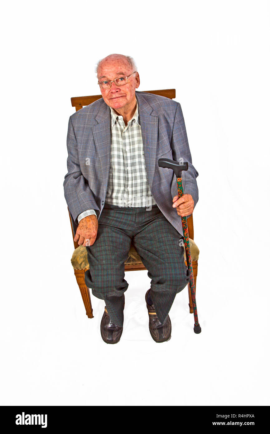 old man sitting in the armchair with his walking stick Stock Photo - Alamy