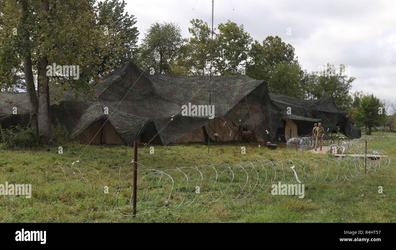 U.S. Soldiers enter and exit the tactical operations center (TOC) for ...