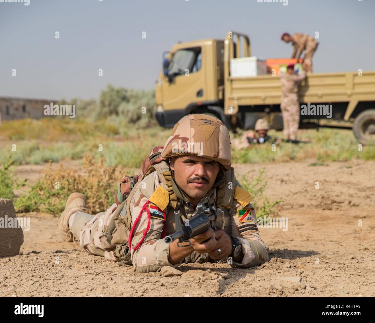 Iraqi army soldier from 3rd Battalion, 41st Brigade lays in the prone ...