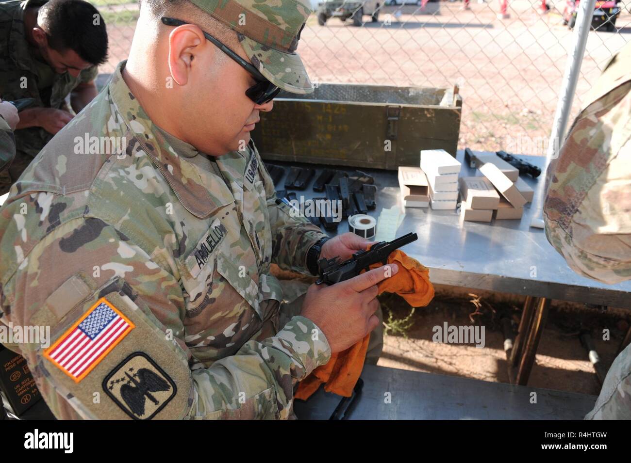 US Army Captain Israel Arguello cleans the M9 9mm pistol after the ...