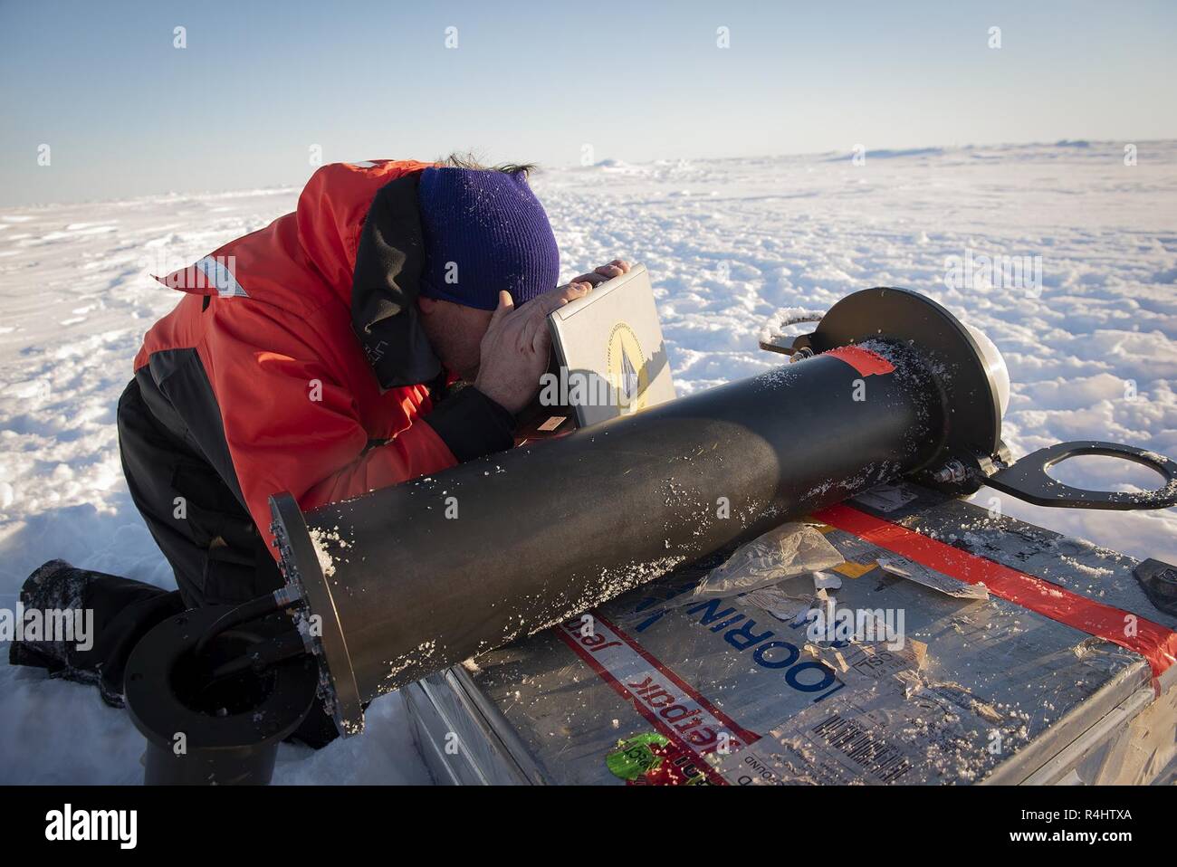 ARCTIC OCEAN – Peter Koski tries to block the sun in order to view his ...