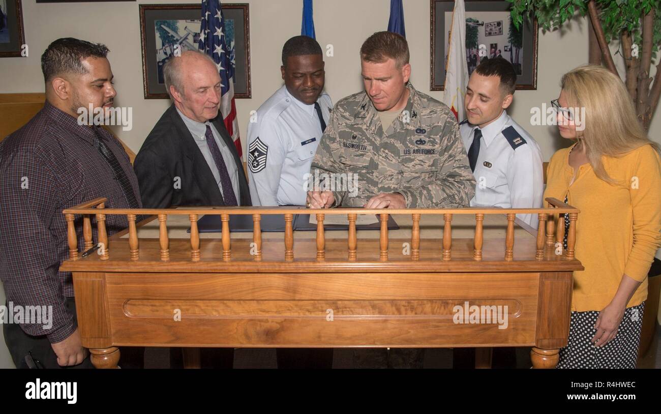 Col. Chad Ellsworth, installation commander, signs a National ...