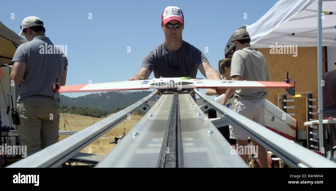 Naval Postgraduate School Alumni Lt. Ray Davis loads an unmanned aerial ...