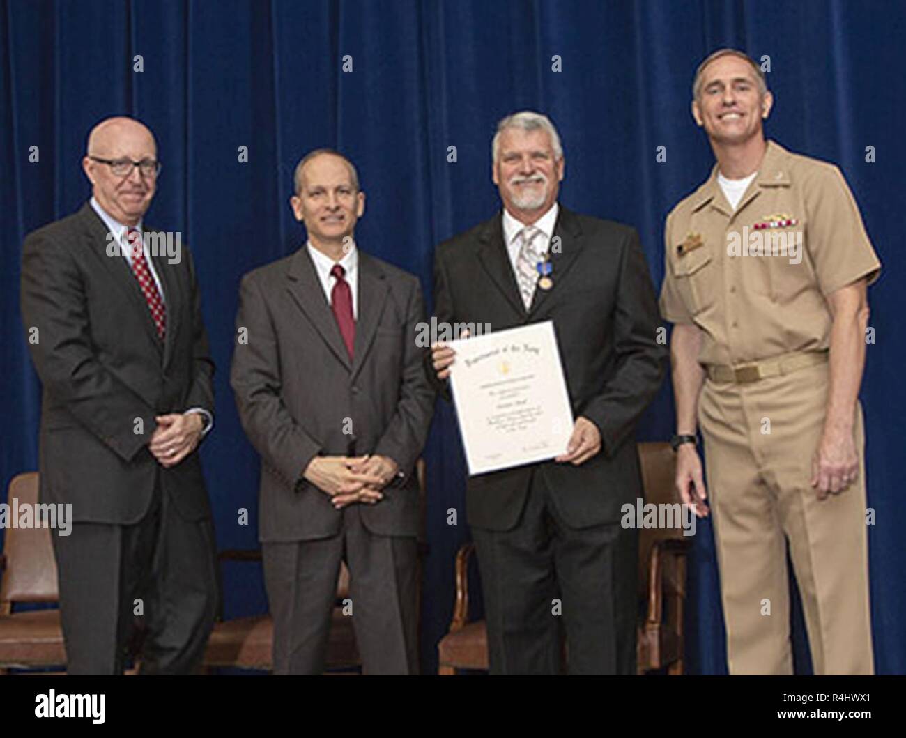 Thomas Floyd (second from right) displays his Department of the Navy ...