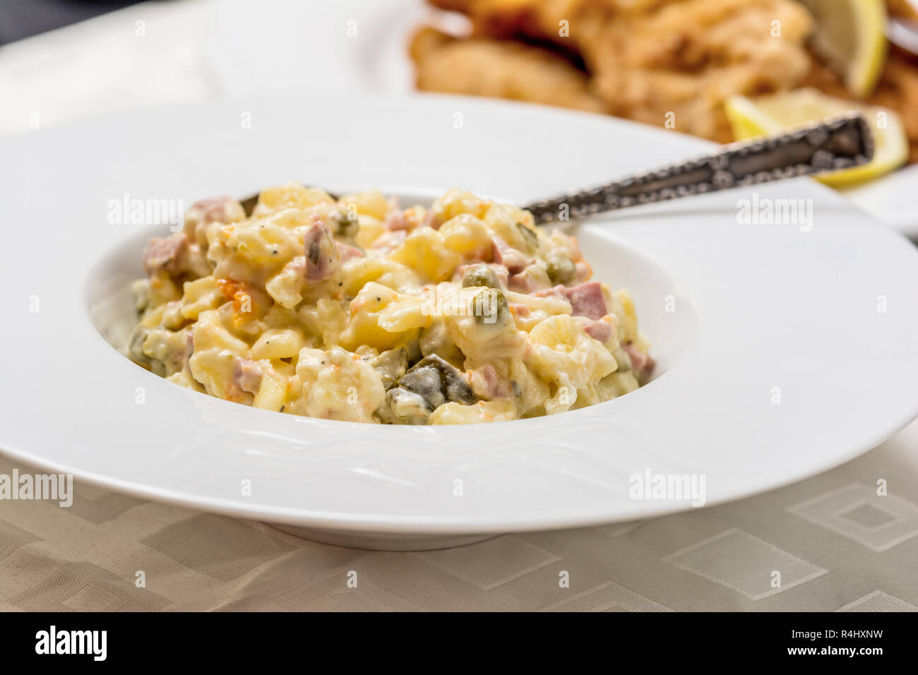 Traditional czech potato salad with mayonnaise and vegetables in white ...