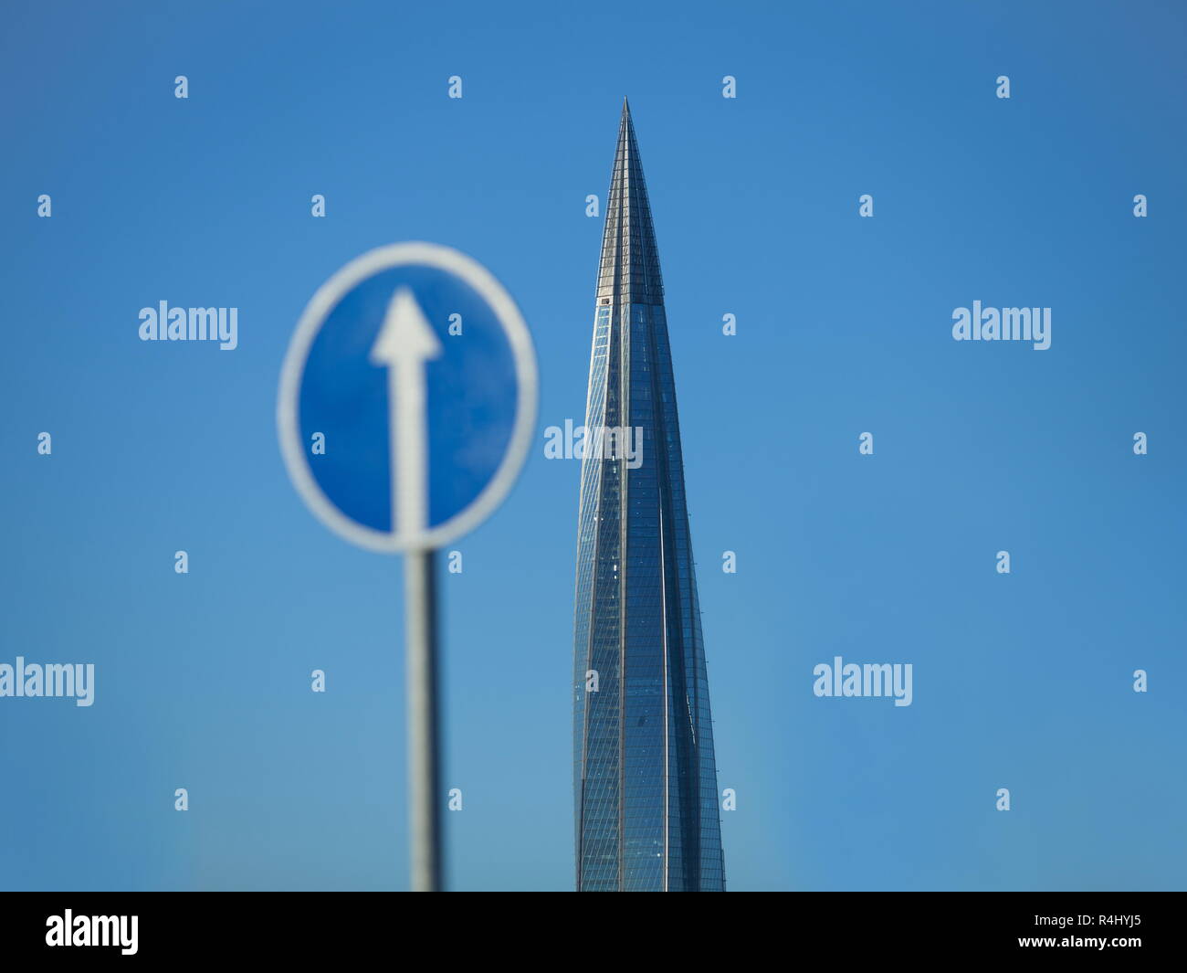 skyscraper spire and a Road sign white arrow up, concept of movement ...
