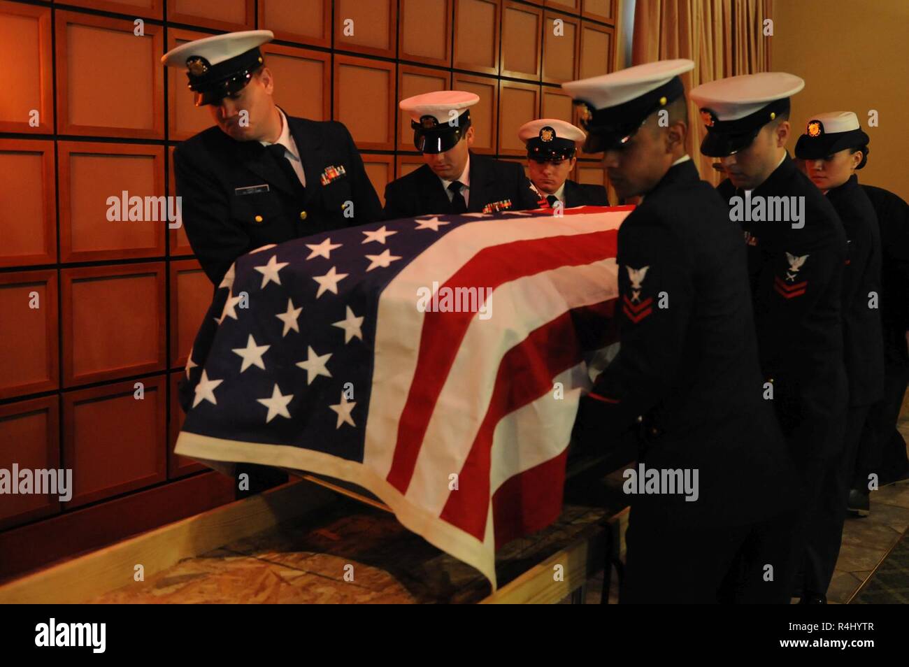 Members of the Coast Guard 13th District honor guard prepare the casket ...